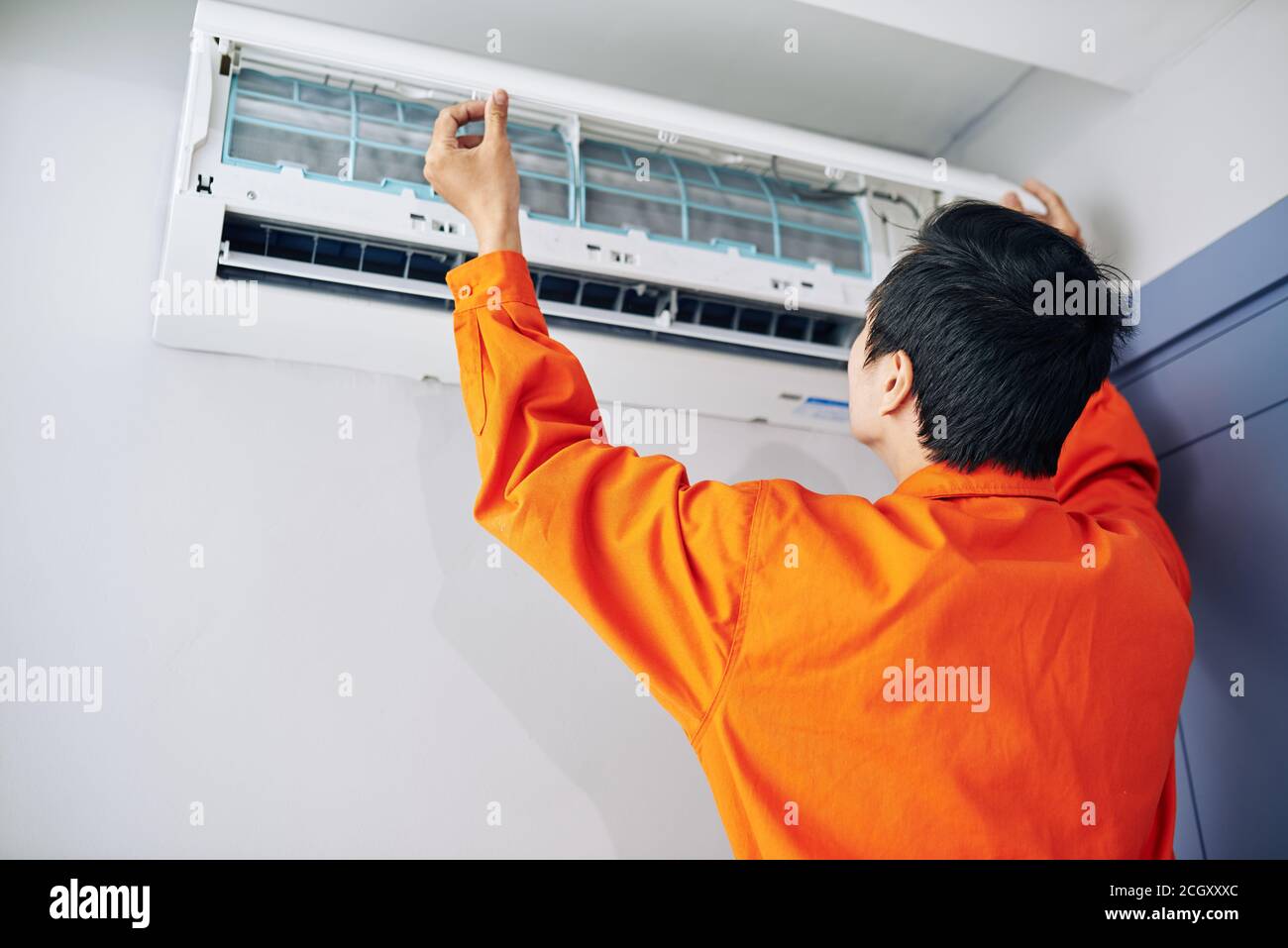 Technician installing conditioner Stock Photo - Alamy