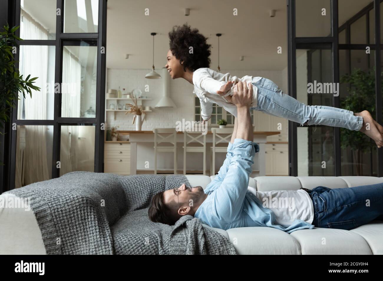 Happy european man having fun with mixed race daughter Stock Photo - Alamy