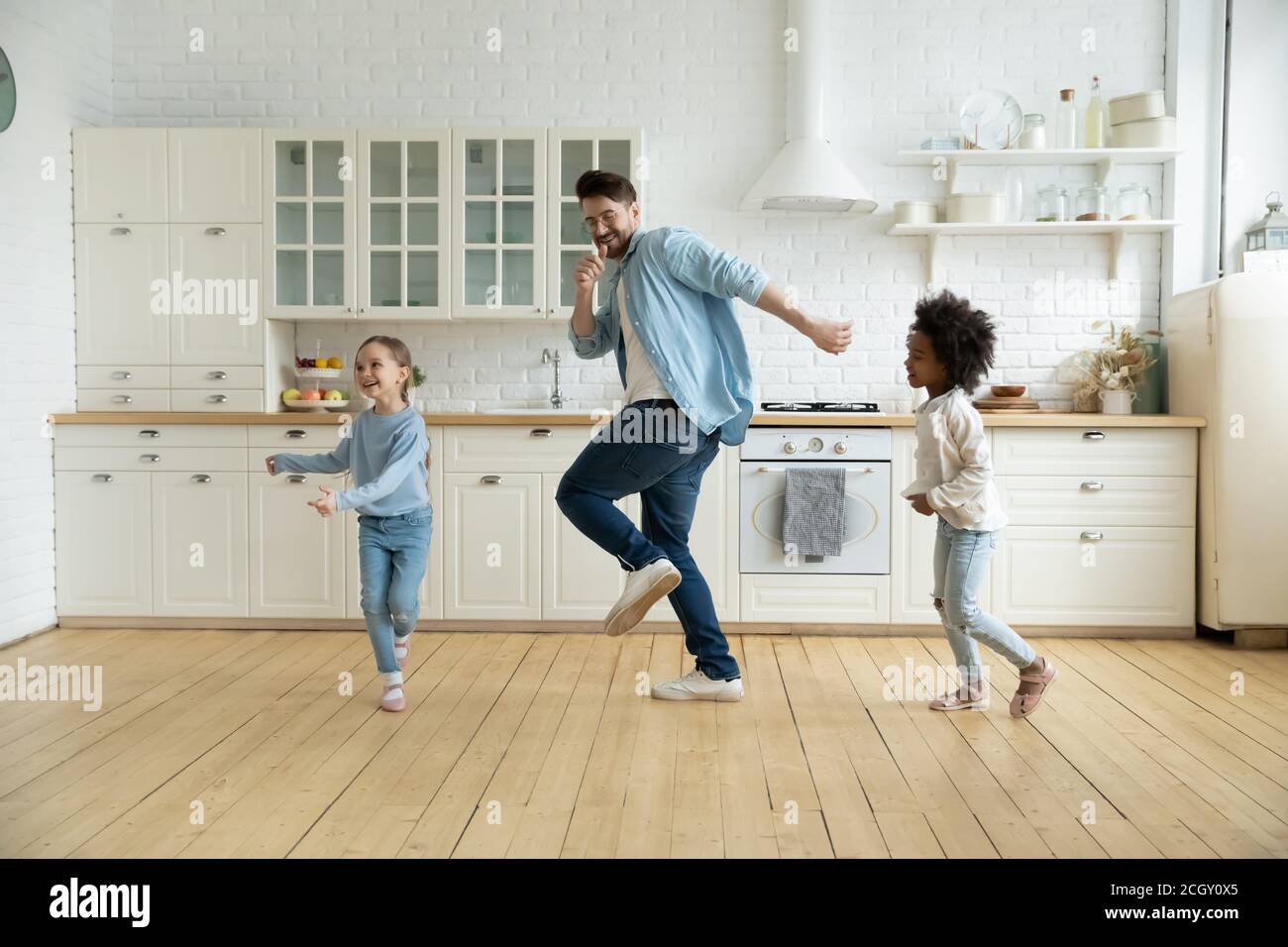 Overjoyed international family dancing, enjoying weekend time Stock ...