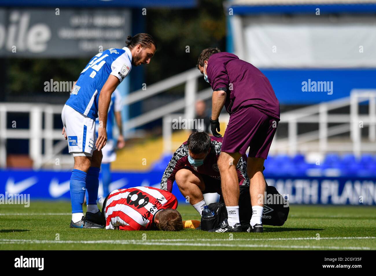 Mathias Jensen (8) of Brentford receives treatment on the pitch Stock ...