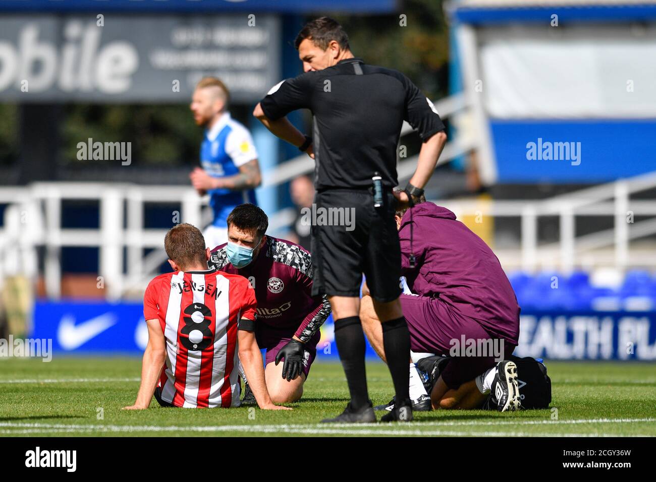 Mathias Jensen (8) of Brentford receives treatment on the pitch Stock ...