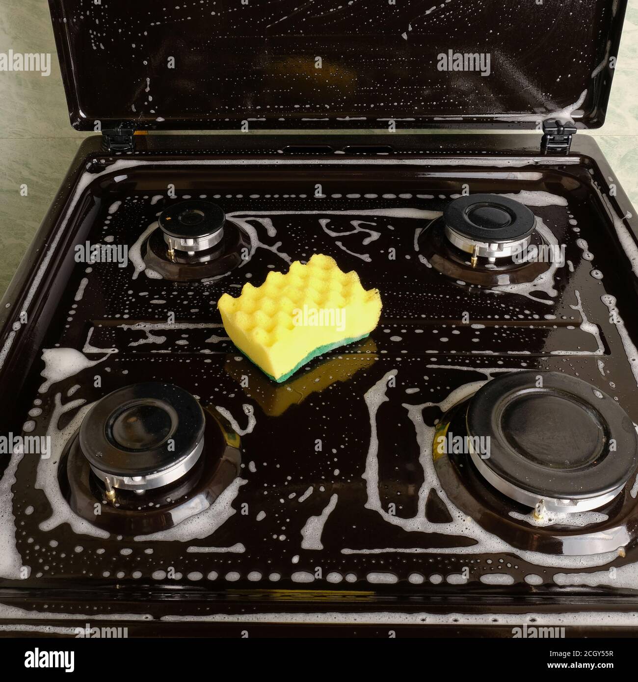 gas stove cleaning, kitchen cleaning Stock Photo - Alamy