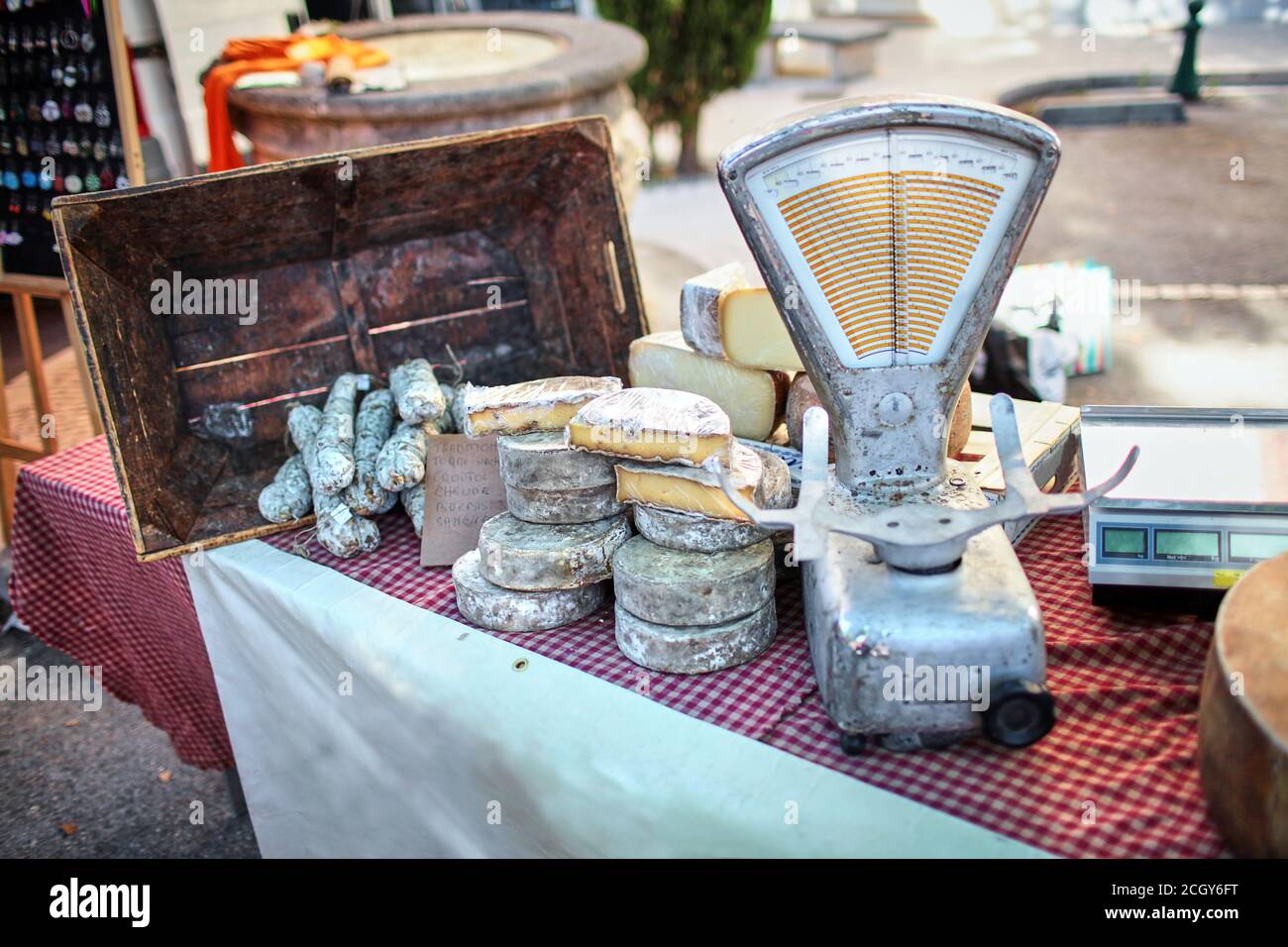 Street market. Different sorts of French cheese on the counter with ...