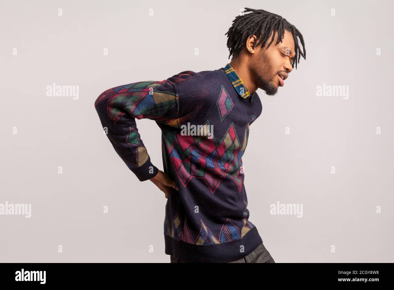 Profile portrait african man with dreadlock cant straighten, suffering ...