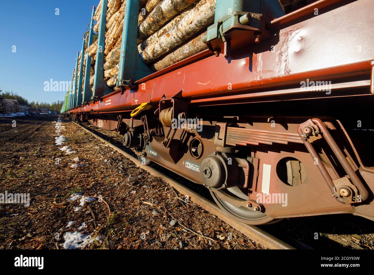 Low-angle closeup view of a log train flatcar wagon ' s undercarriage ...