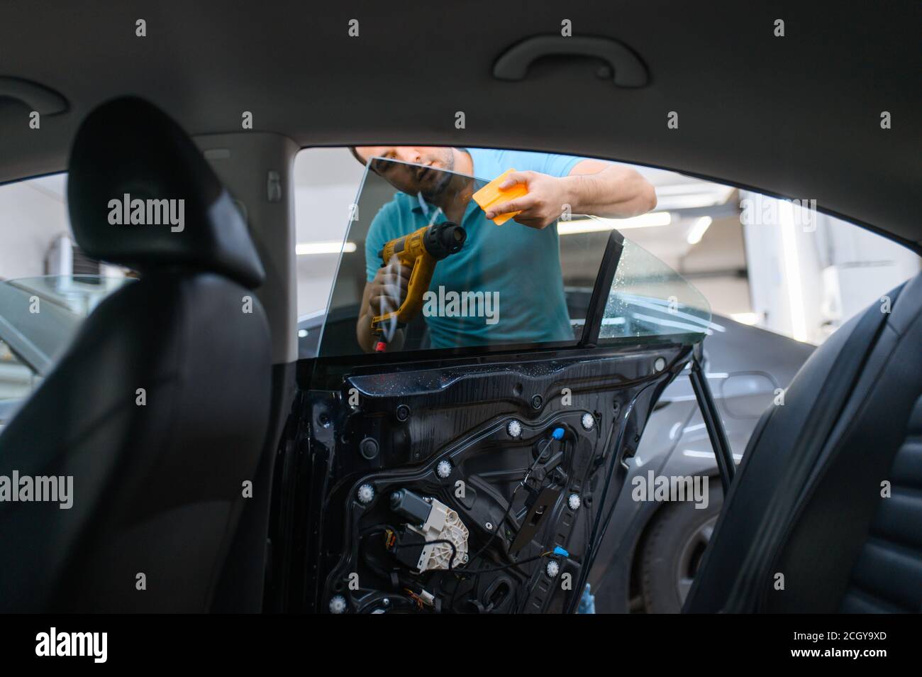 Specialist installs wetted car tinting, tuning Stock Photo - Alamy