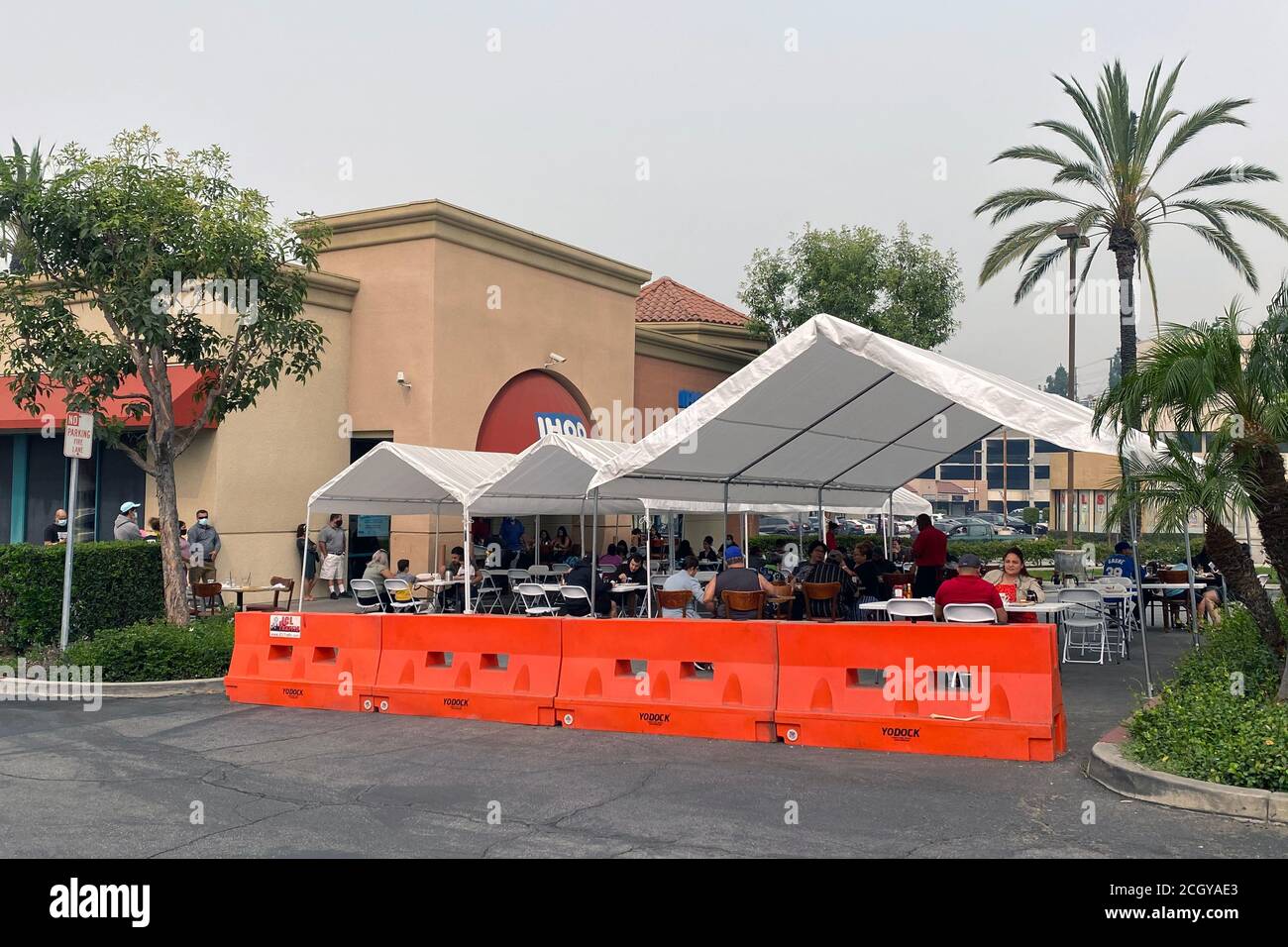 An outdoor dining area in the parking lot at IHOP restaurant amid the ...