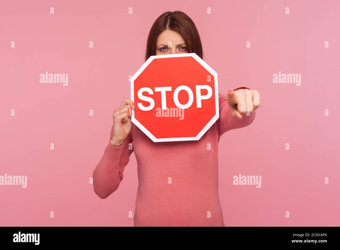 Angry Strict Woman In Pink Sweater Holding Stop Warning Sign And