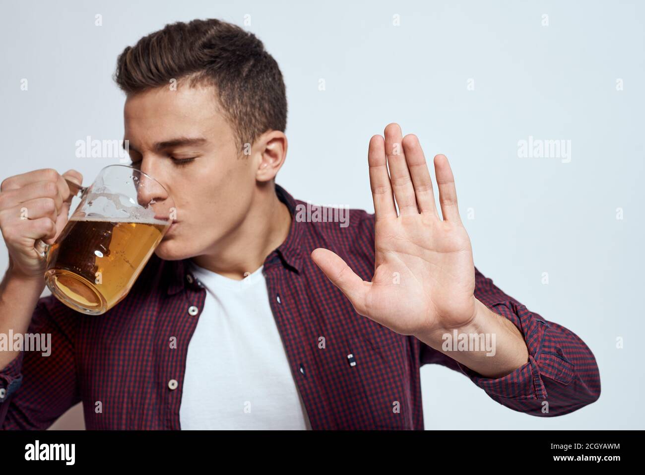 Drunk man with a mug of beer vacation alcohol lifestyle in a red shirt ...