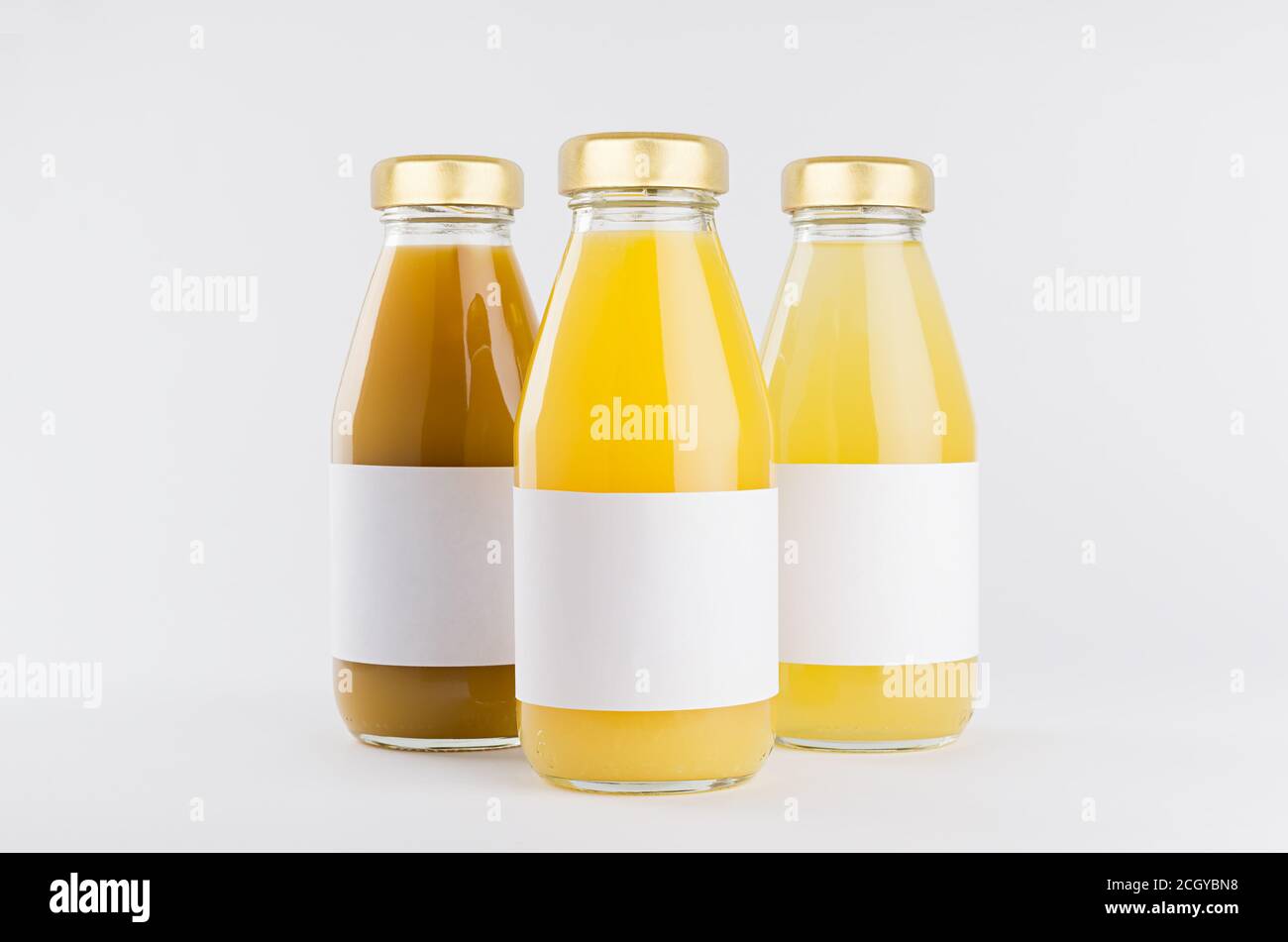 Orange, yellow fruit juices collection in glass bottles with cap, white ...