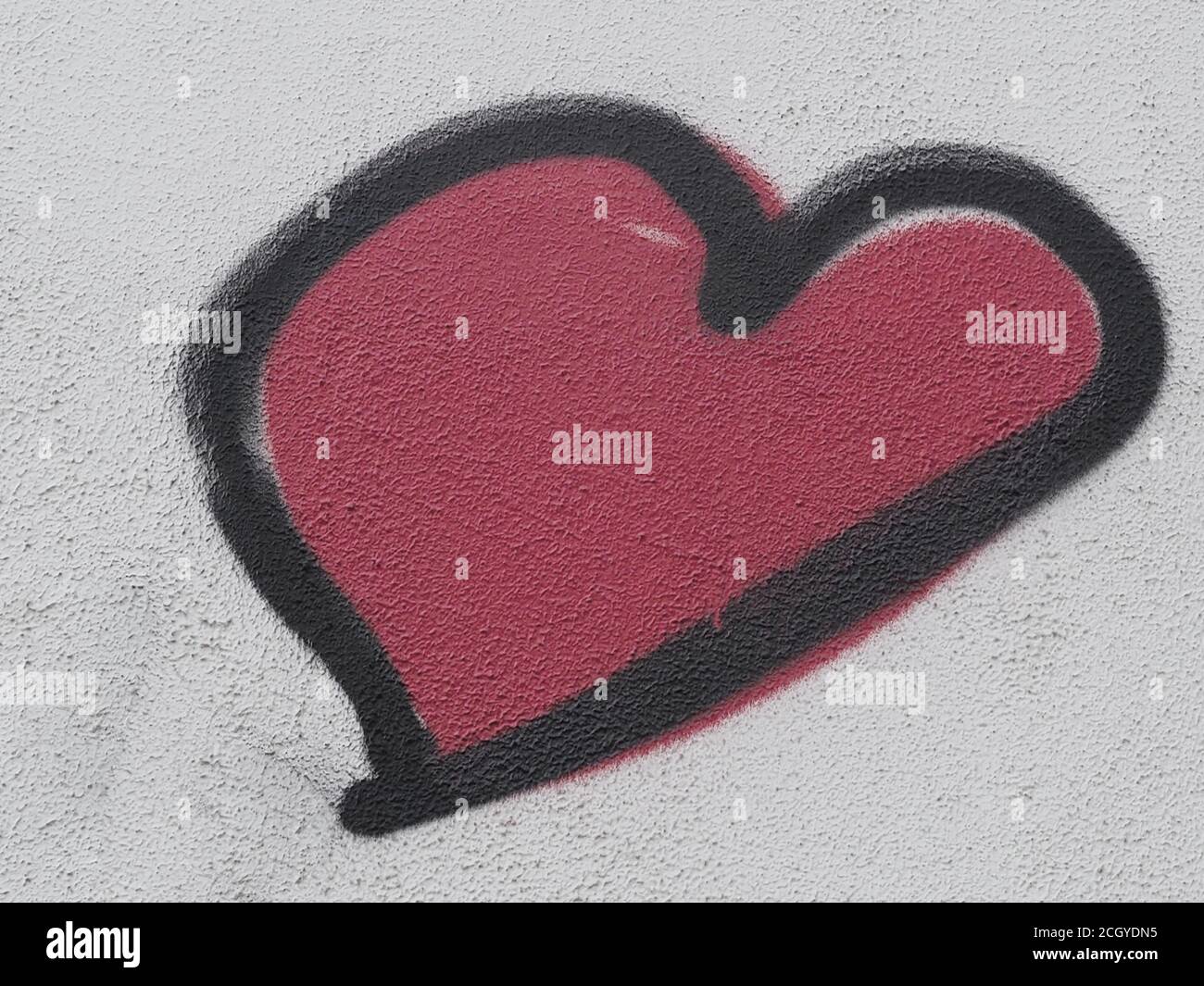 Red heart on a white wall for love Stock Photo - Alamy