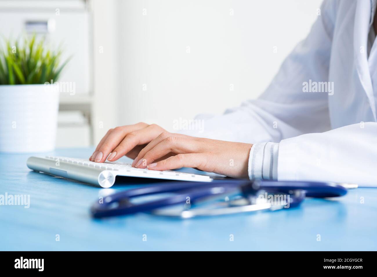 Doctor typing at computer keyboard Stock Photo - Alamy