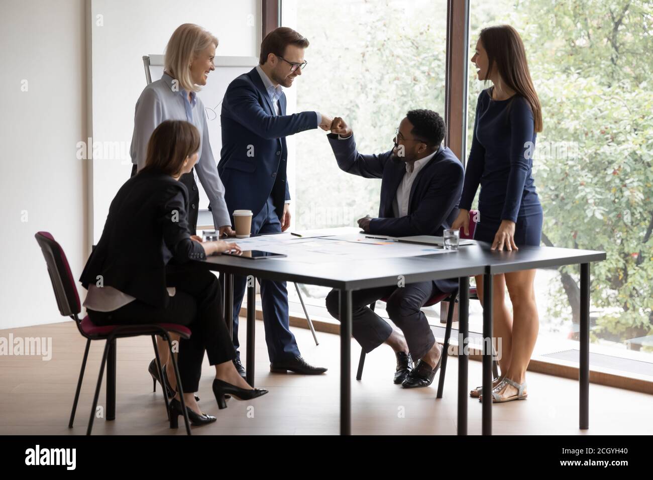 Smiling diverse colleagues have fun brainstorming in office Stock Photo ...