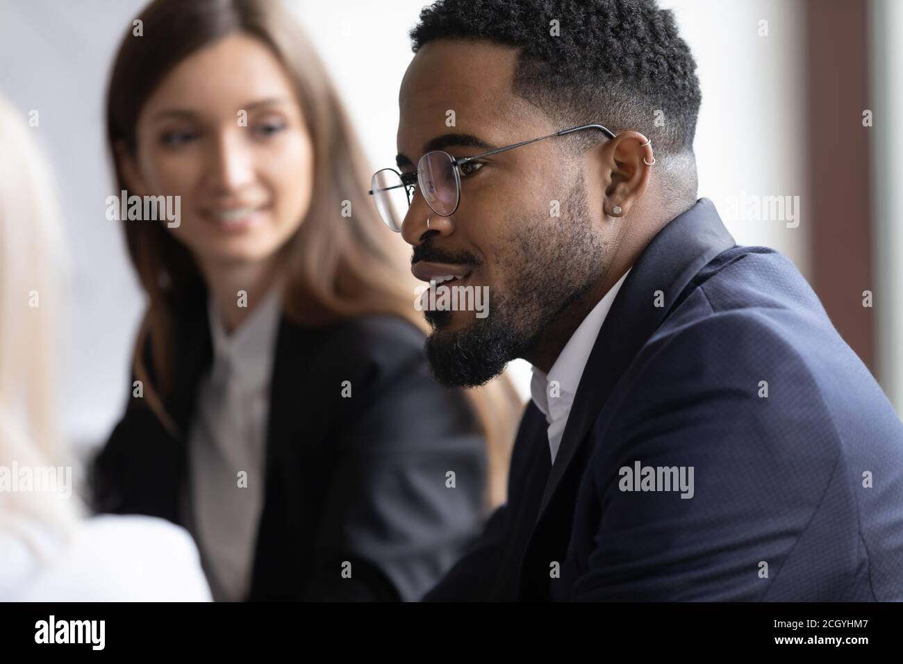 Confident biracial male employee talk at meeting with colleagues Stock ...