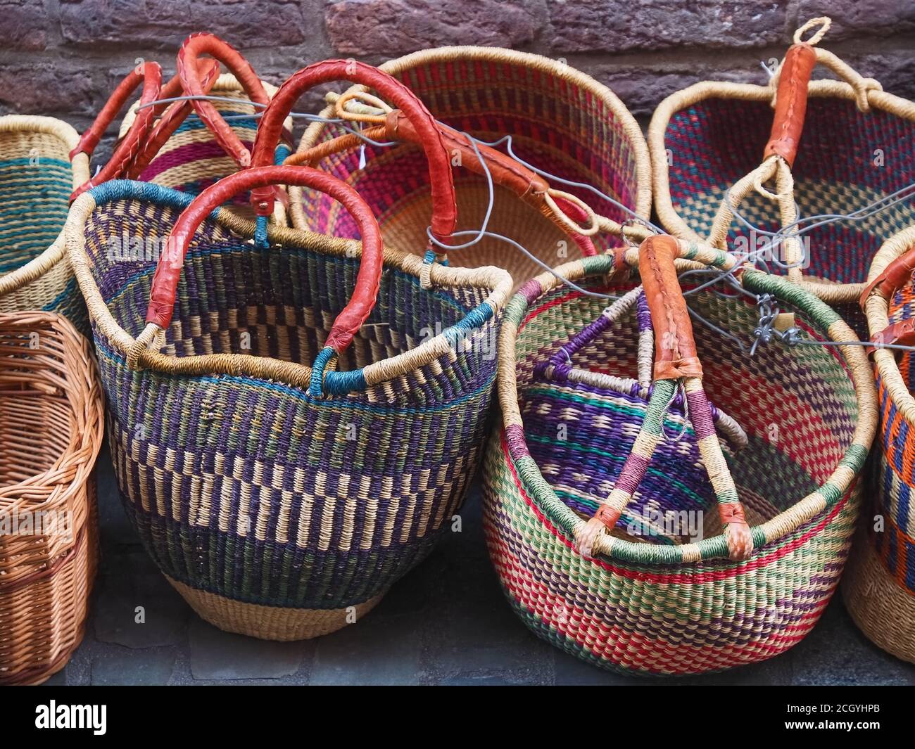 Colorful woven shopping baskets at a street market Stock Photo - Alamy