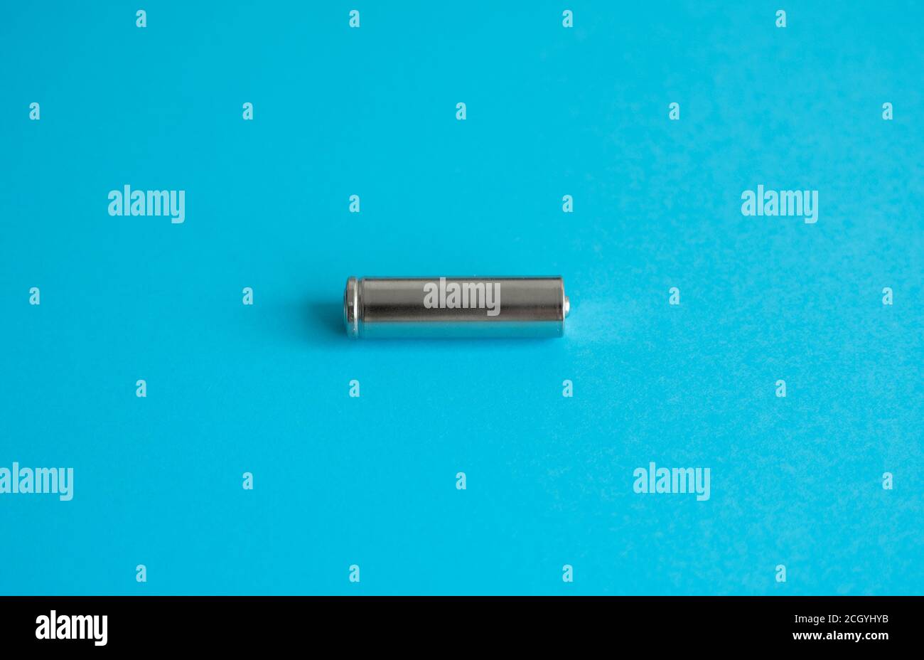 A single rechargeable battery on blue background. Silver alkaline AA ...