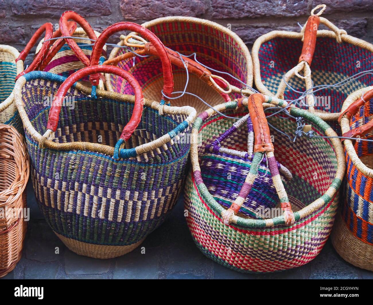 Colorful woven shopping baskets at a street market Stock Photo - Alamy