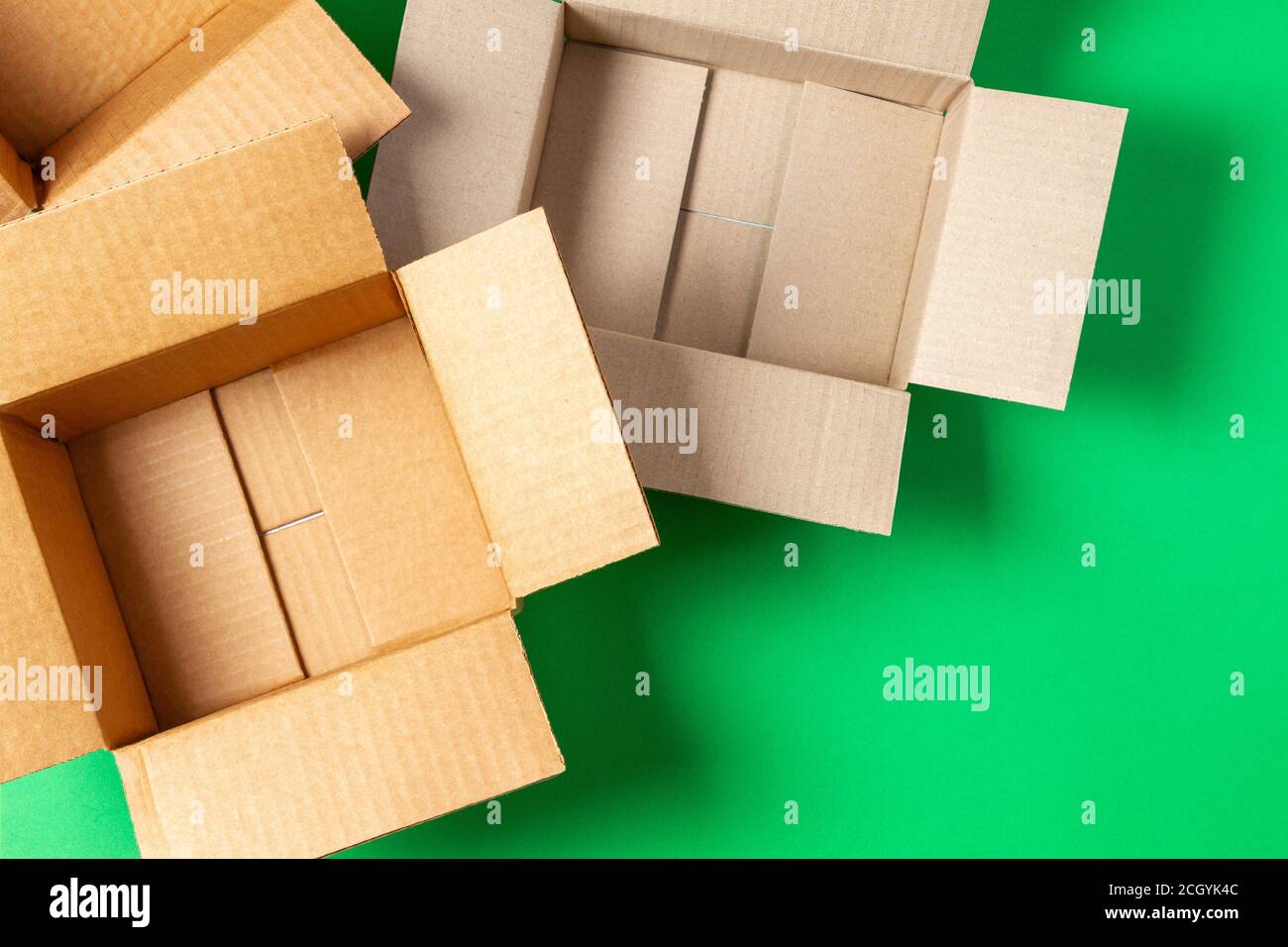 Empty open cardboard boxes on light green background. Top view Stock ...
