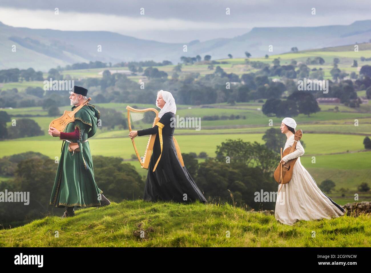 Left to right Chris Elmes holds a citole, Cait Webb holds a medieval ...