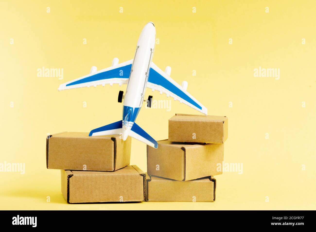 Airplane and stack of cardboard boxes. concept of air cargo and parcels ...