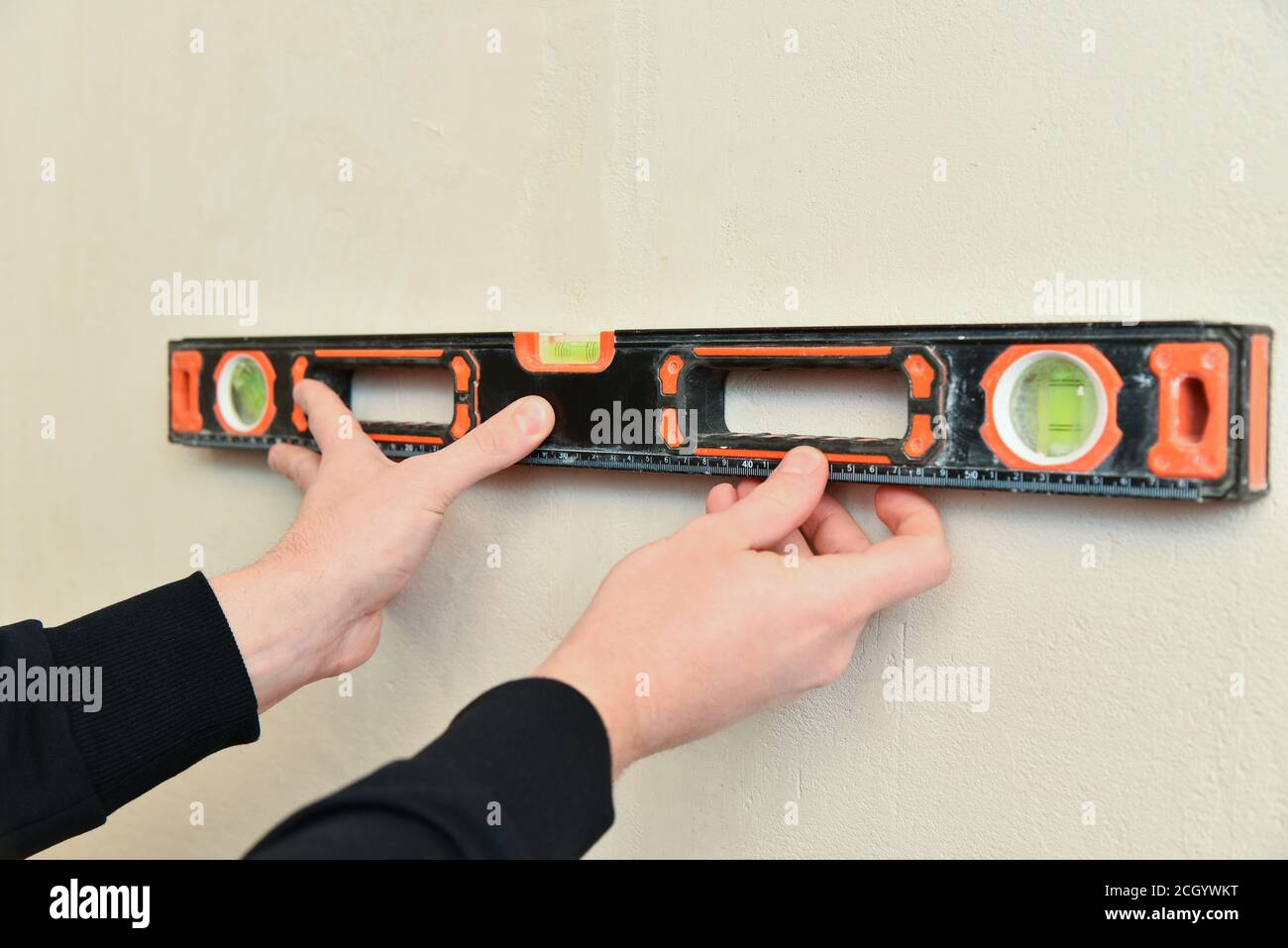 Professional measuring equipment. Worker hold in hand spirit level ...