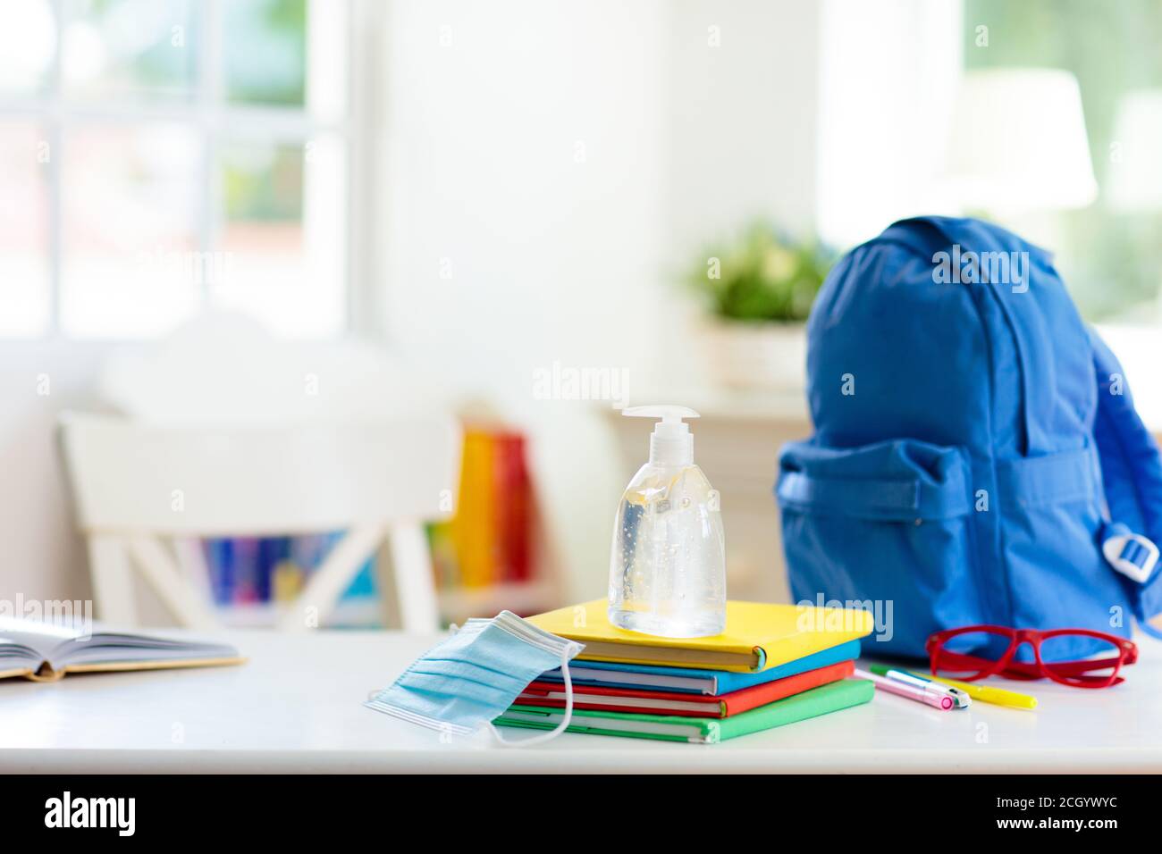 Backpack of school child with face mask and sanitizer. Student safety ...