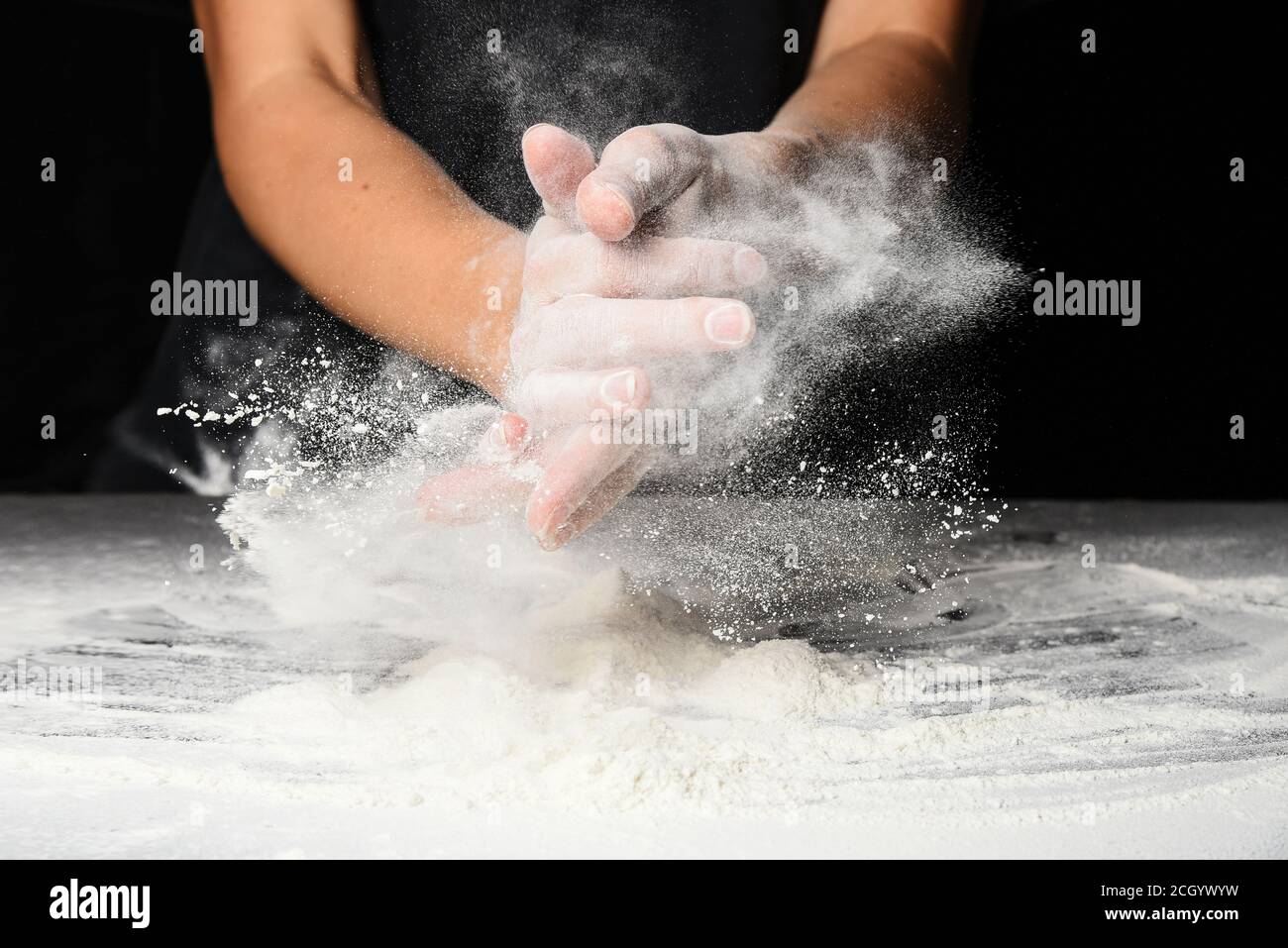 Chef woman prepare bread at home. Hands of the cook splash clap with ...