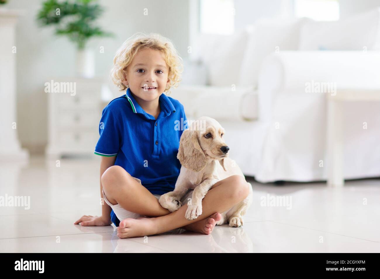 Child playing with baby dog. Kids play with puppy. Little boy and ...