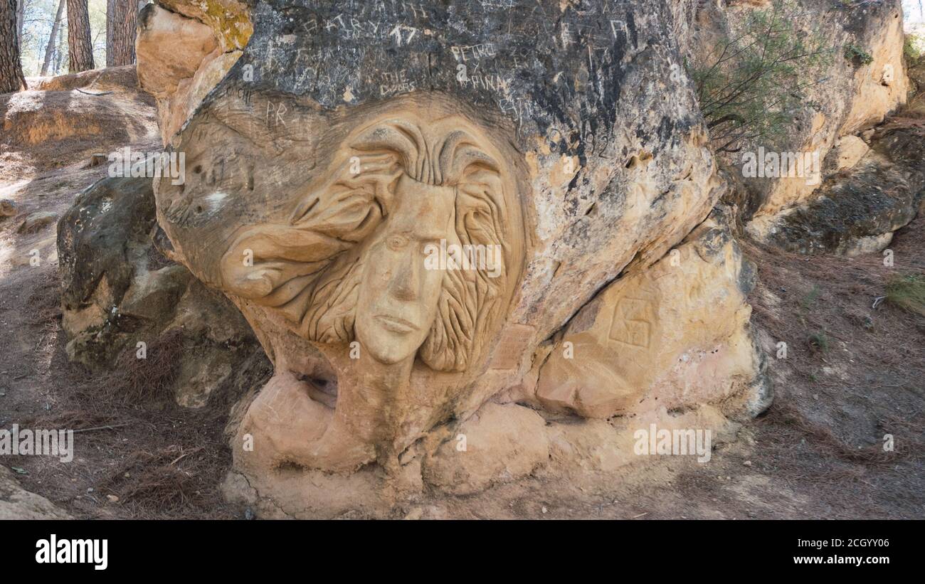 Faces carved in stone on the Route of Faces Stock Photo - Alamy