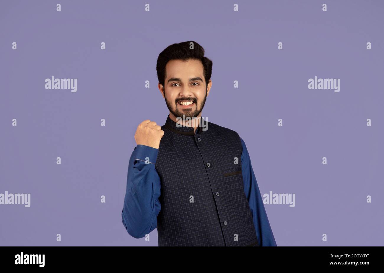 Attractive Indian guy with smile on his face making YES gesture on ...