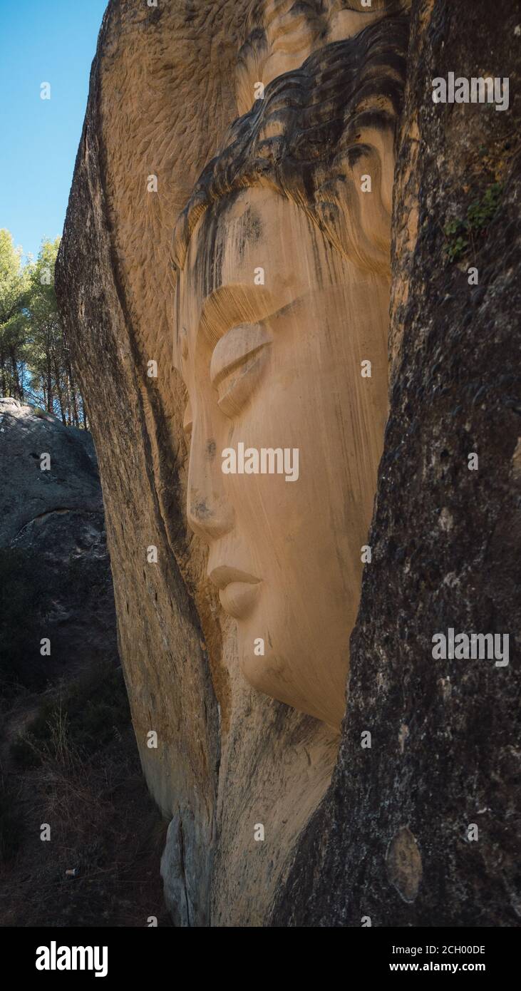 Faces carved in stone on the Route of Faces Stock Photo - Alamy
