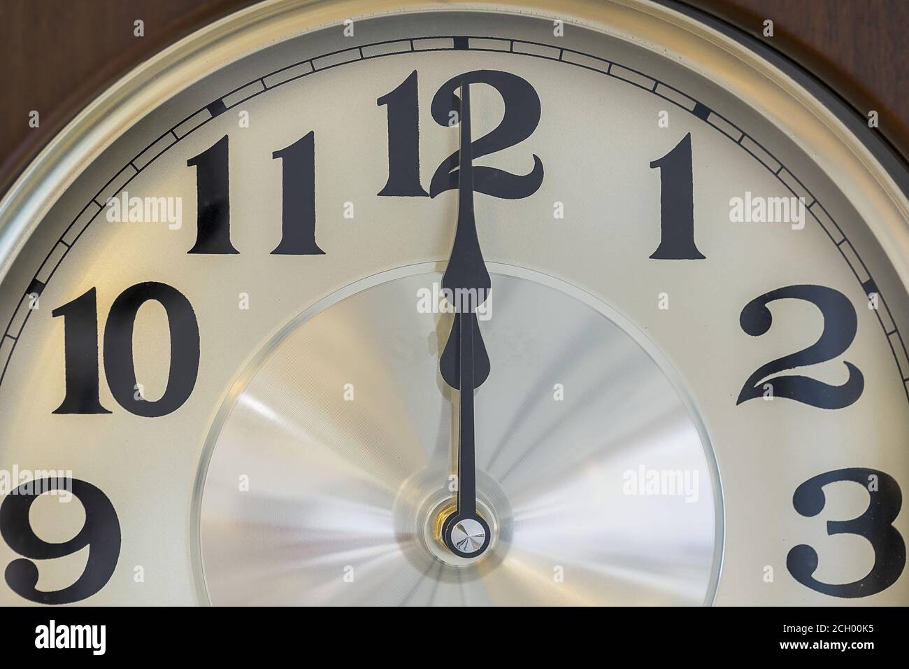 Close up macro view of brown clock with light clock face showing twelve ...