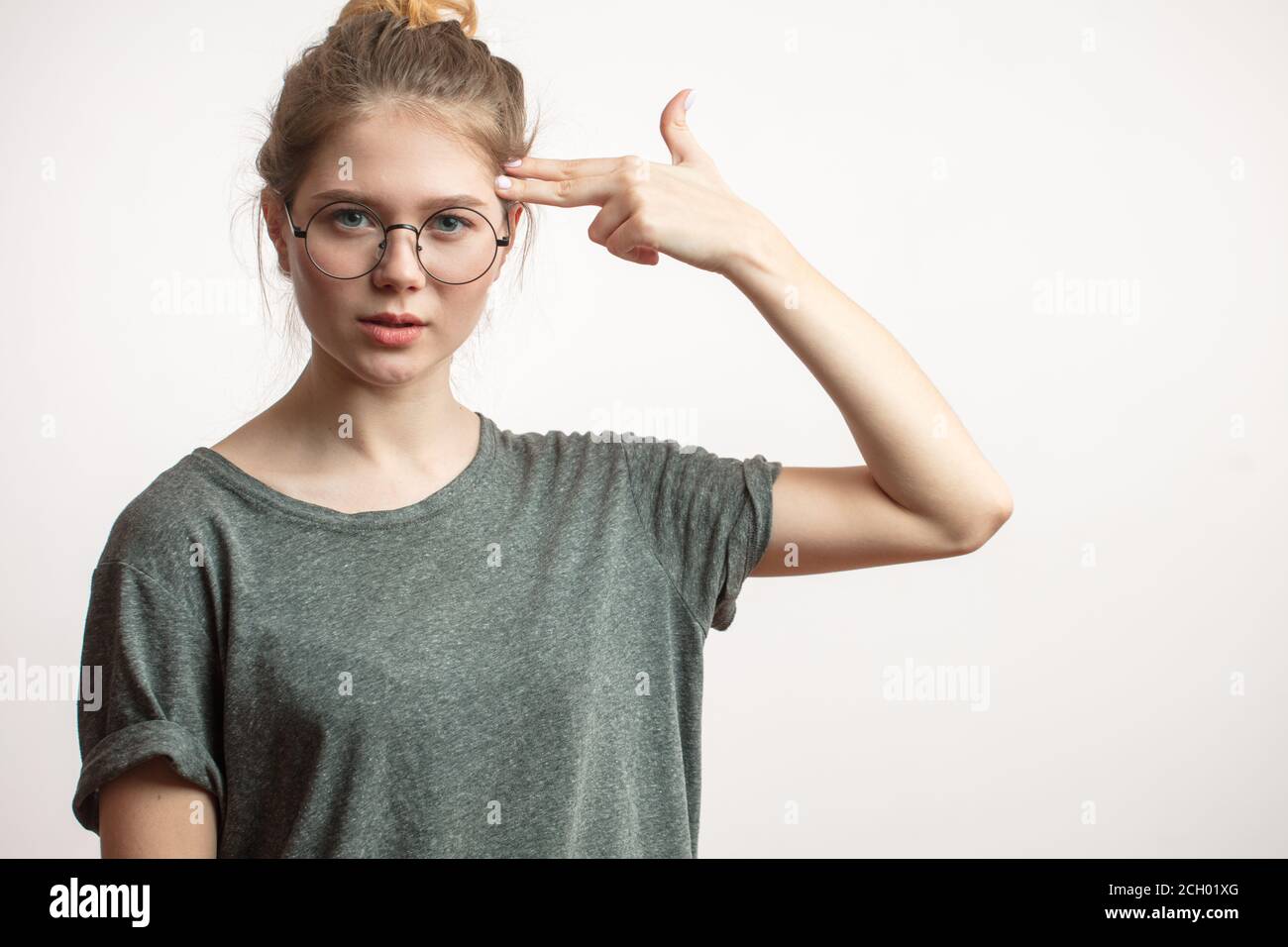 Beautiful young distressed woman making suicide gesture, tired of ...