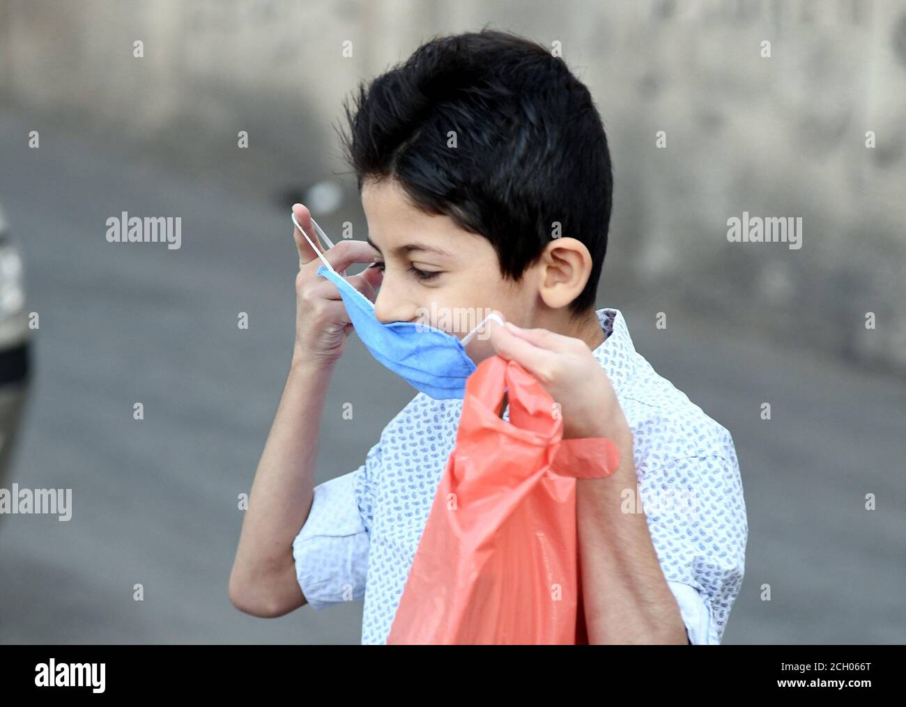 Damascus. 13th Sep, 2020. A school boy puts on a face mask in Damascus ...