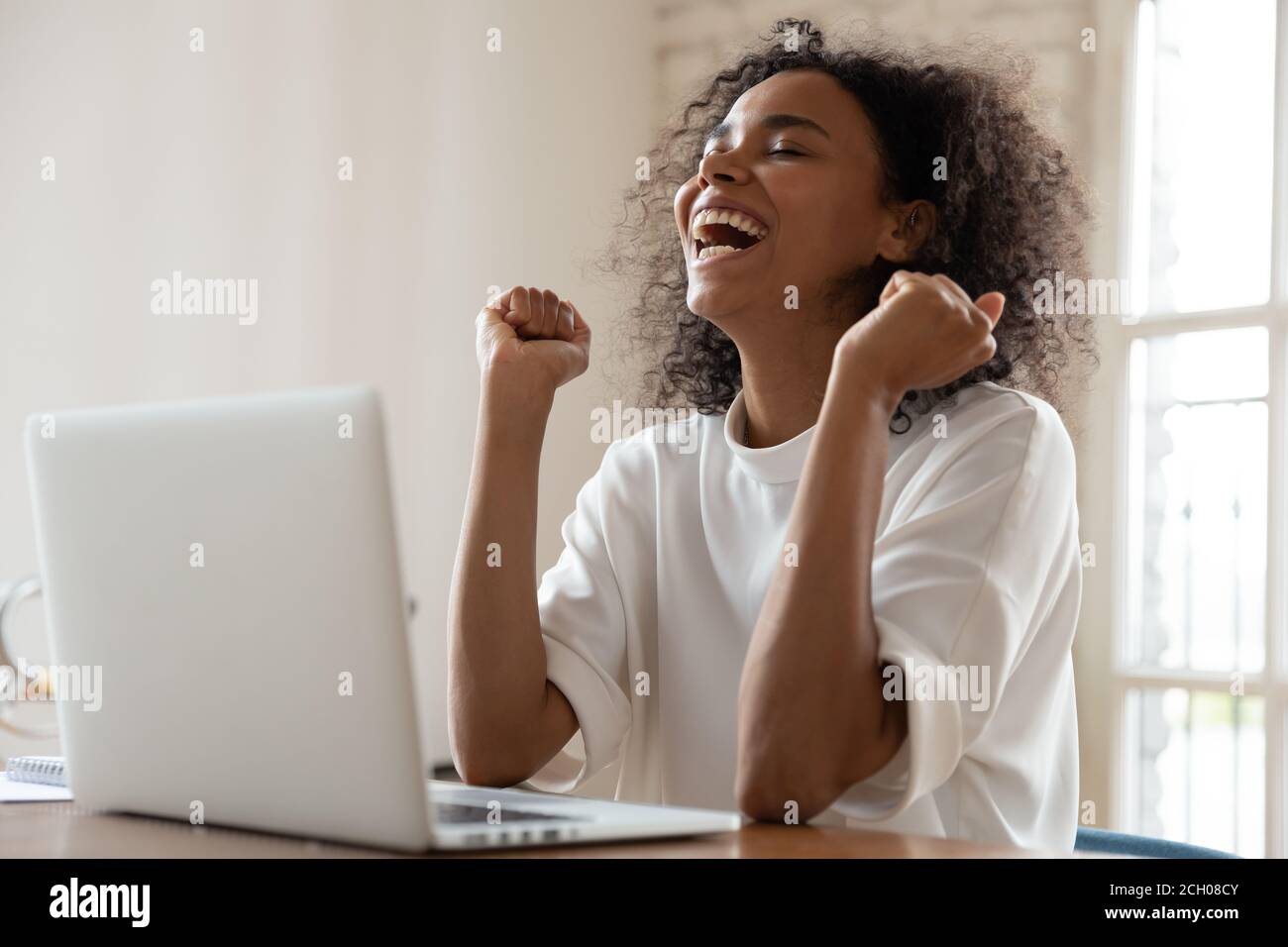 Excited african businesswoman celebrating success hi-res stock ...