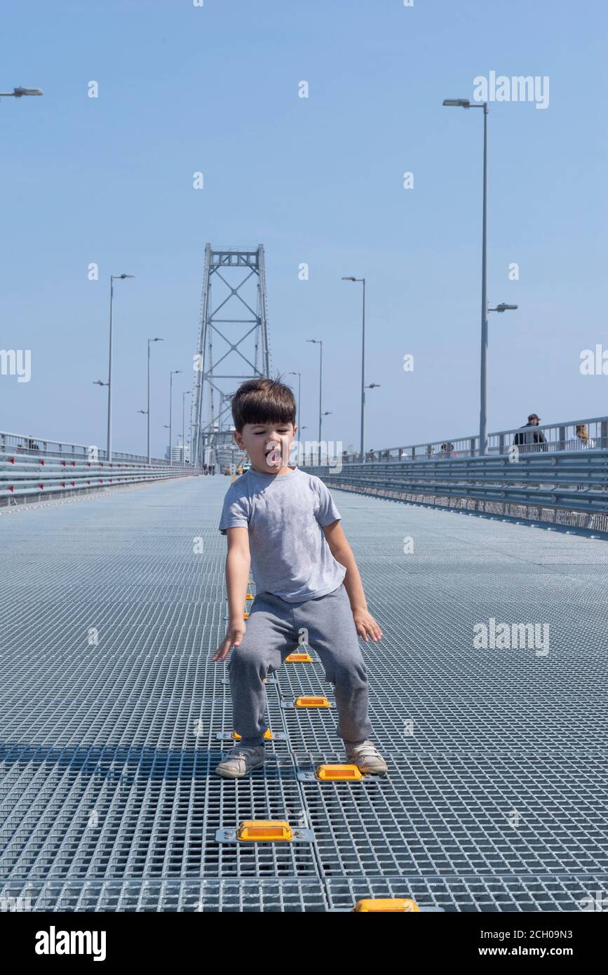 Isolated. Boy jumping with arms and legs open. Happy little boy ...