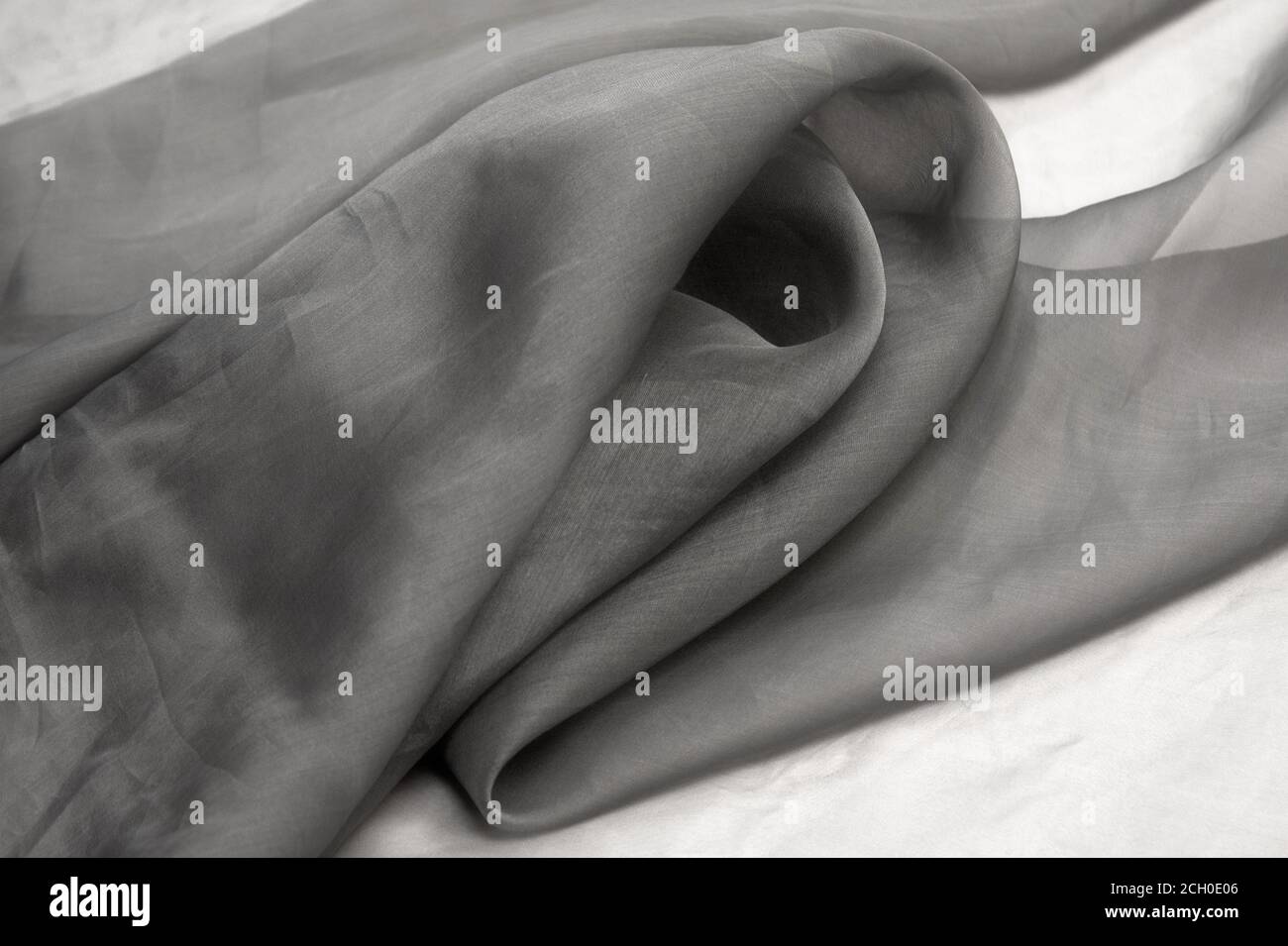 Twisted twirl of organza fabric gray texture Stock Photo - Alamy