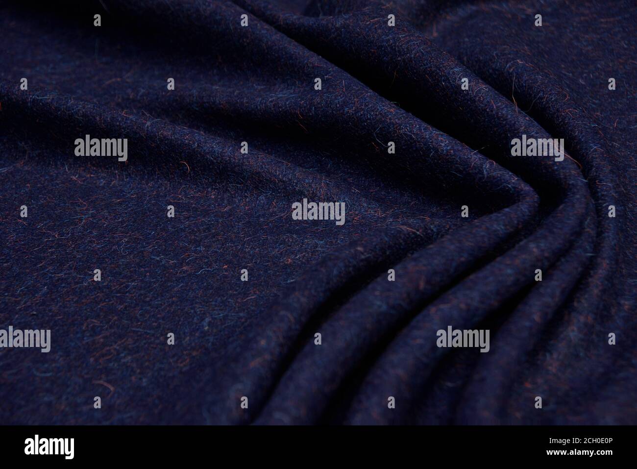Dark blue wool for coat. Close up texture of the fabric is useful as a ...
