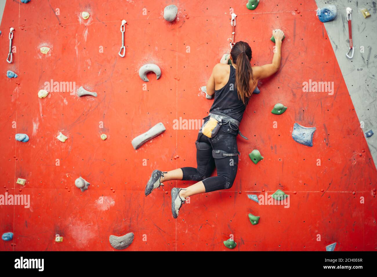 Attractive sporty woman making efforts for a big step up on an ...