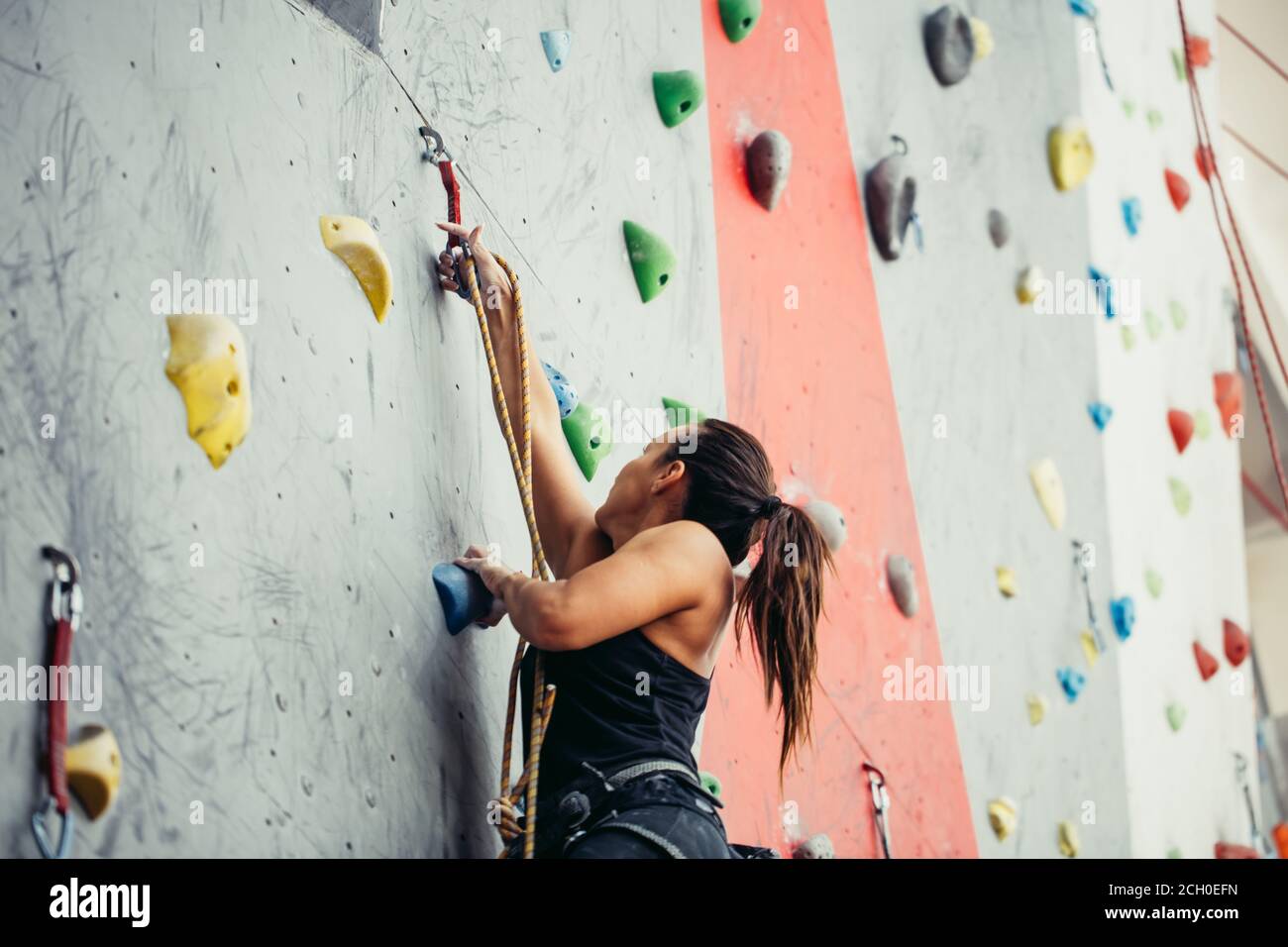 Attractive sporty woman making efforts for a big step up on an ...