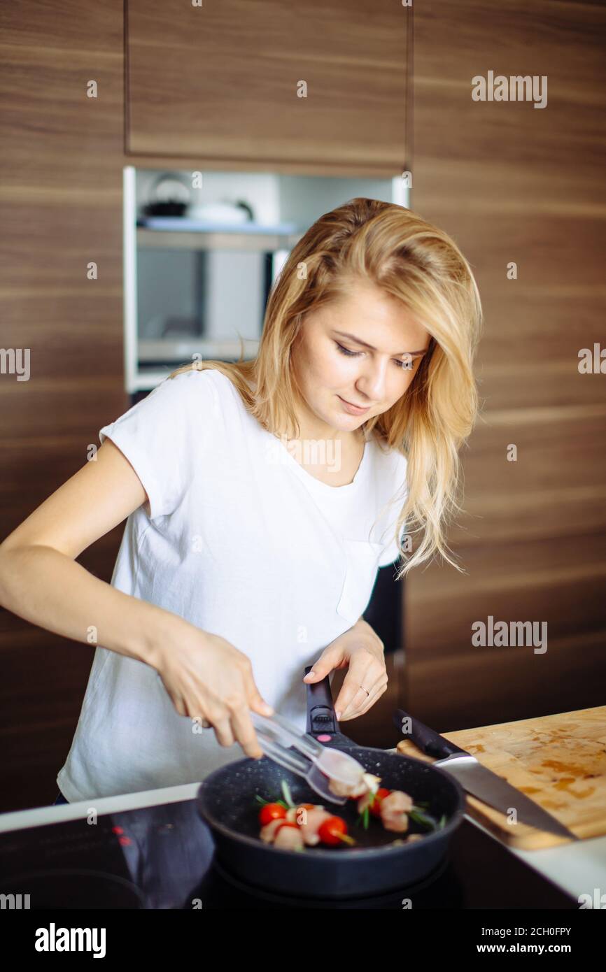 Blonde woman cooking husband hi-res stock photography and images - Alamy