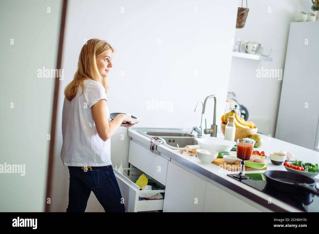 Young woman washing plates and another kitchen stuff after lunch Stock ...