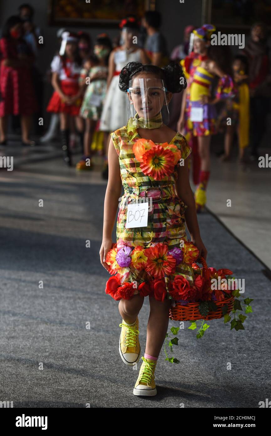 Tangerang, Indonesia. 13th Sep, 2020. A girl wearing a face shield and ...