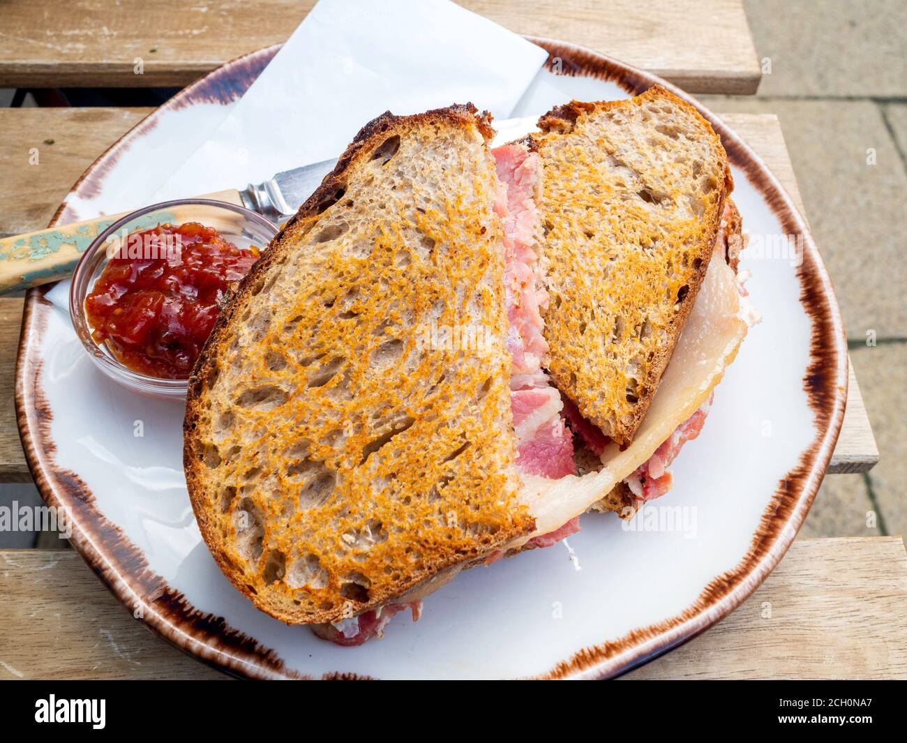 Lunch snack Bacon sandwich on bloomer Bread with pickle on an outside ...