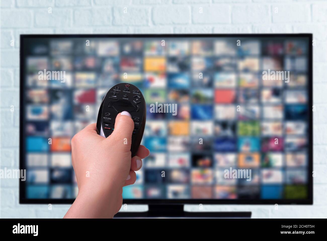 Multimedia streaming concept. female hand holding remote control. TV ...