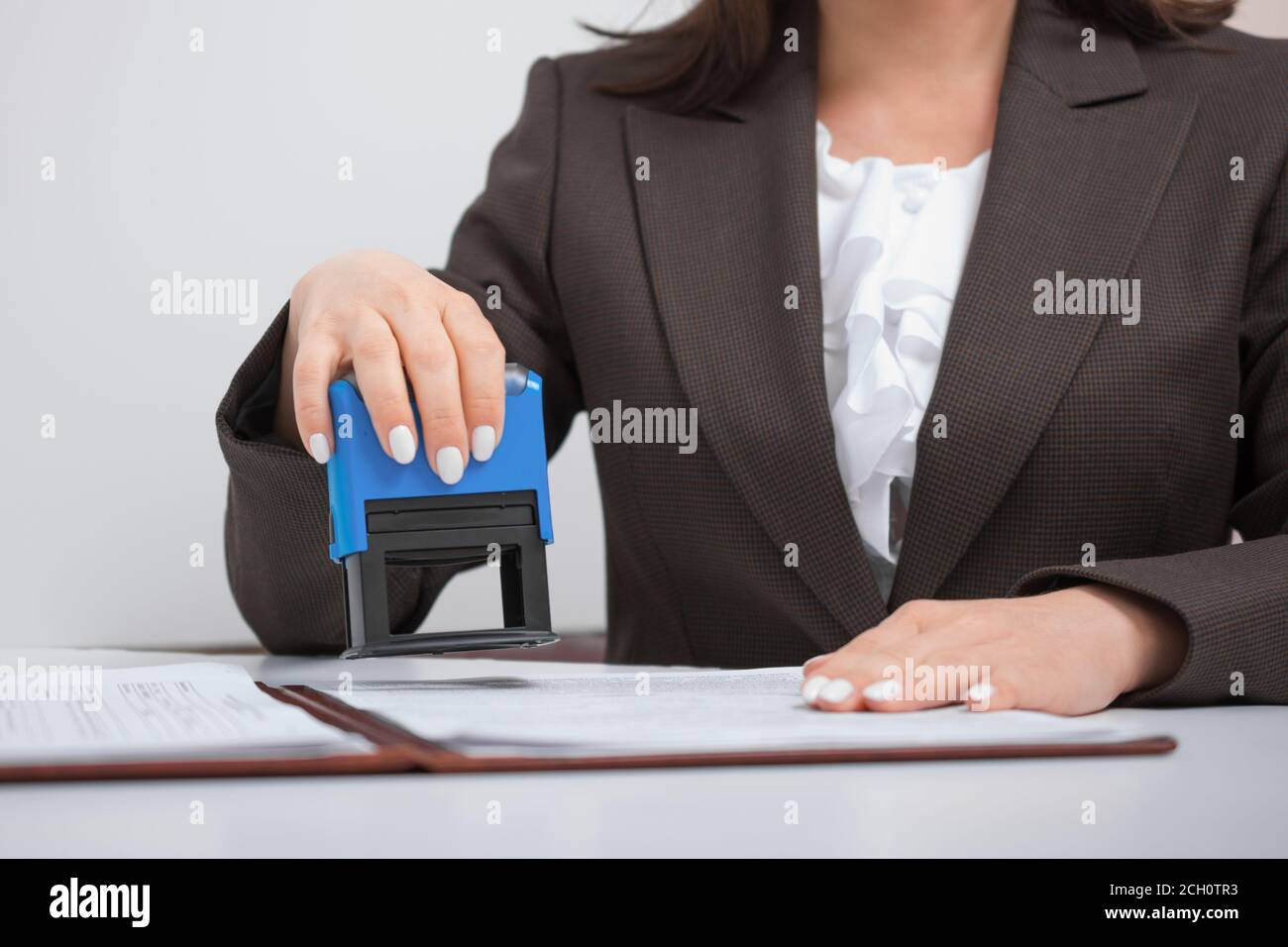 businesswoman clerk office worker Putting Stamp On Documents Stock ...