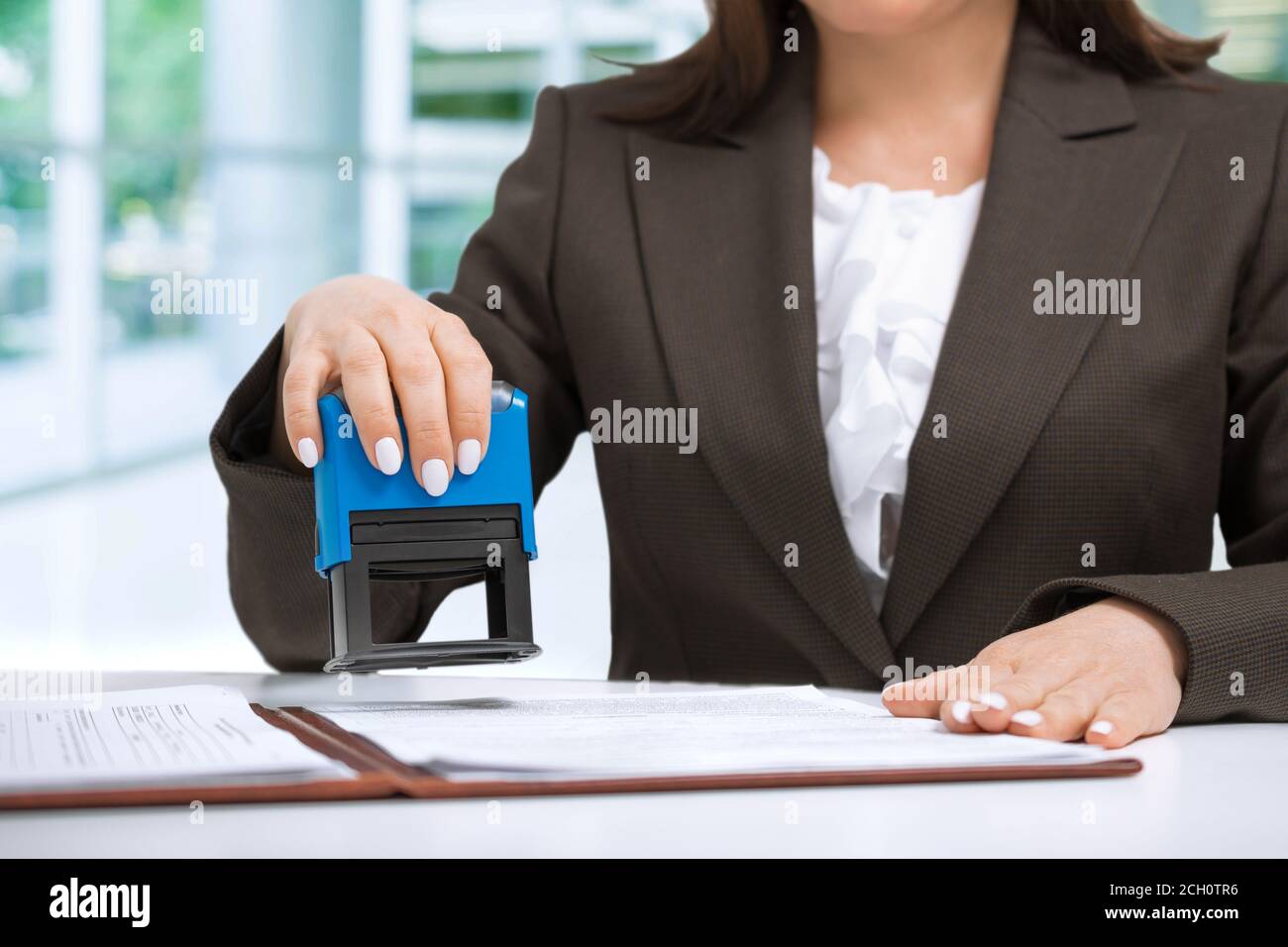 businesswoman clerk Putting Stamp On Documents in the office, Office ...