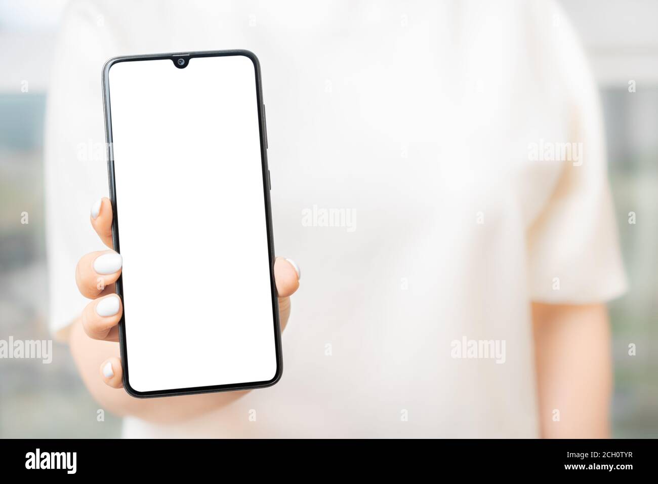 Woman showing phone with blank screen. Women hand show the white mobile ...