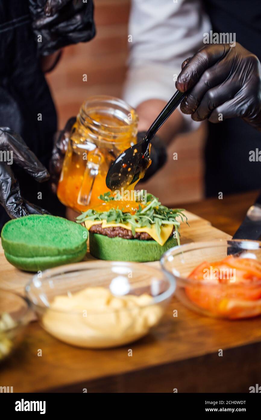 Chef making beef burgers indoor on kitchen international food festival ...