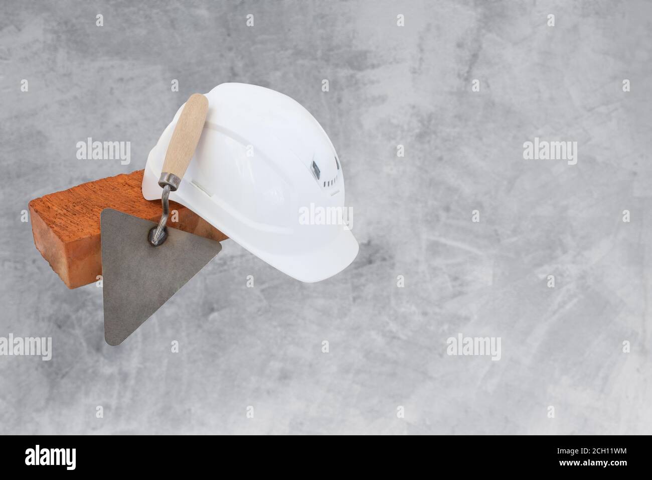 Bricklayer tools. Mason tools - Trowel, bricks and white helmet ...